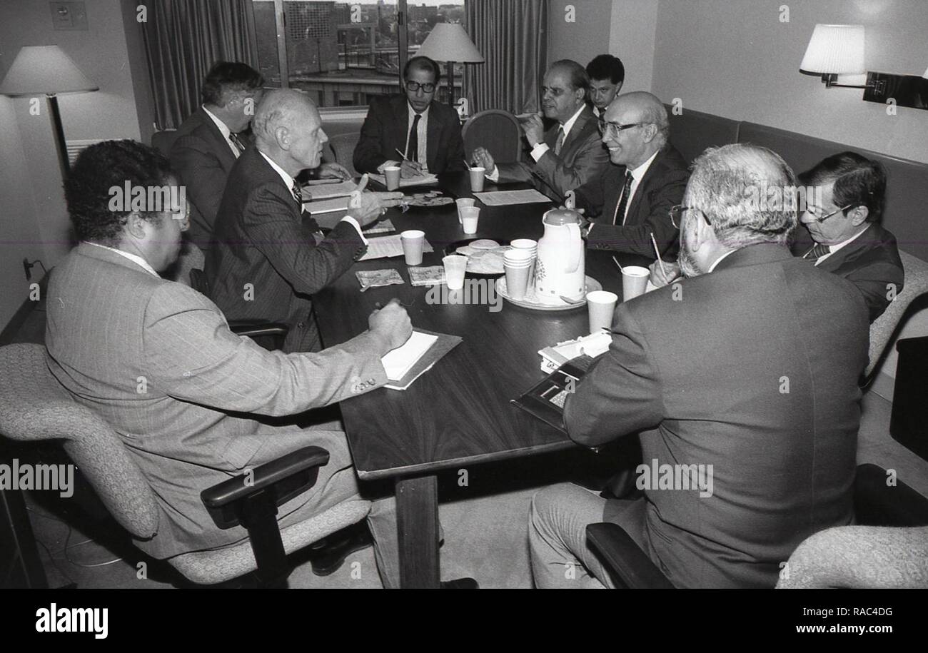 GROUP OF MEN SITTING AROUND THE TABLE HAVING A MEETING Stock Photo - Alamy