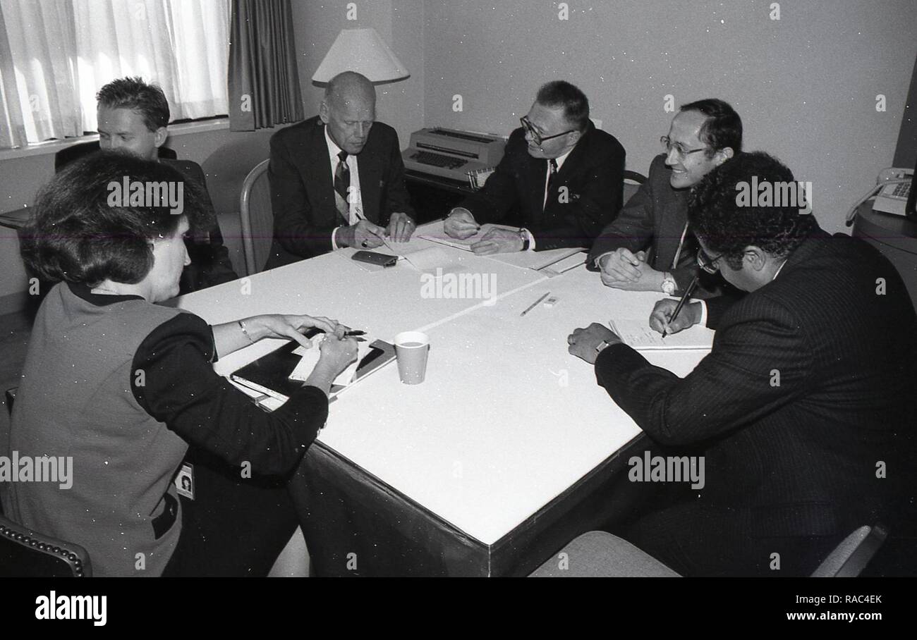 FIVE MEN AND ONE WOMAN SITTING AT THE TABLE WRITING Stock Photo - Alamy