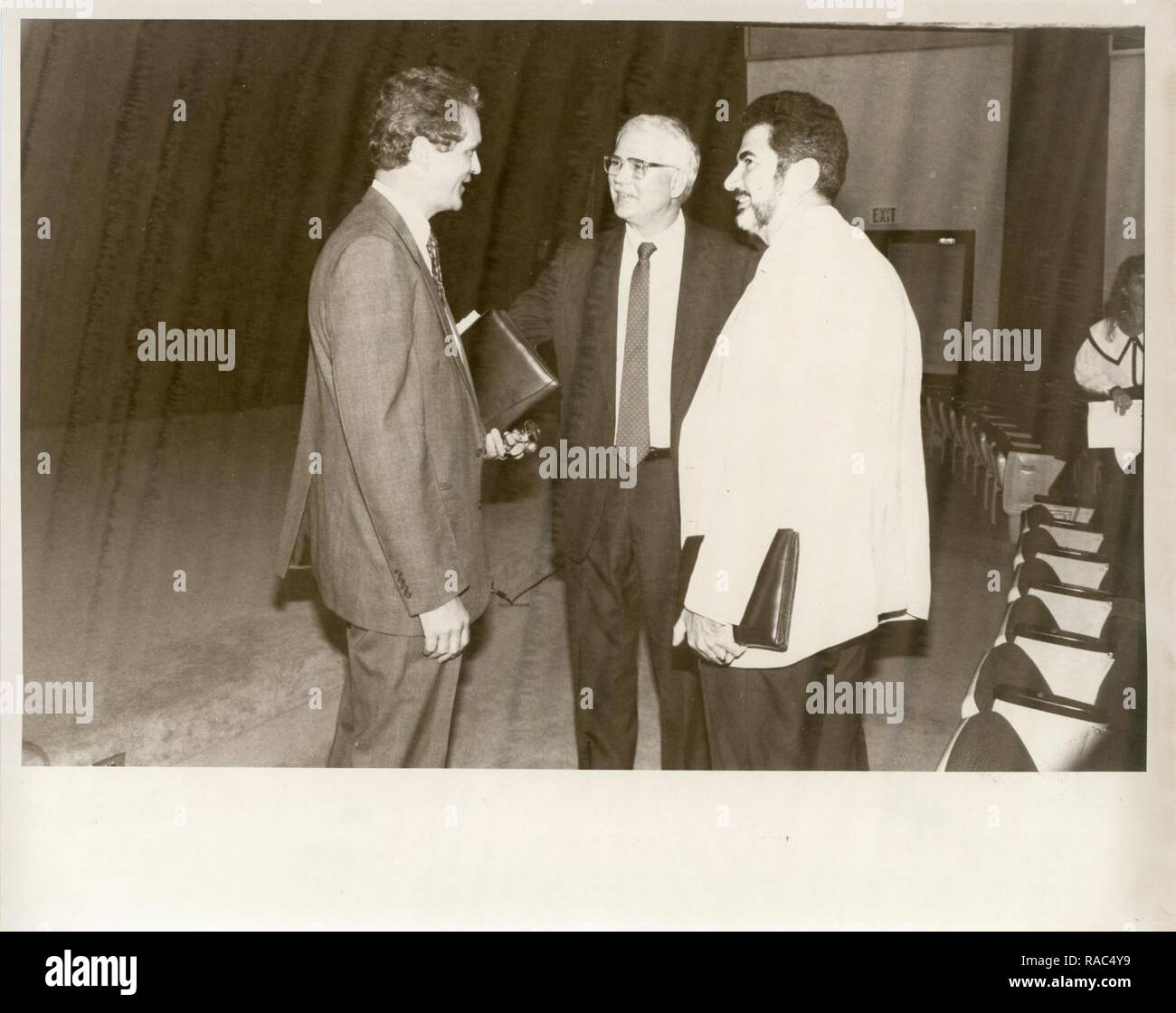 THREE MEN ARE HAVING A CONVERSATION Stock Photo - Alamy
