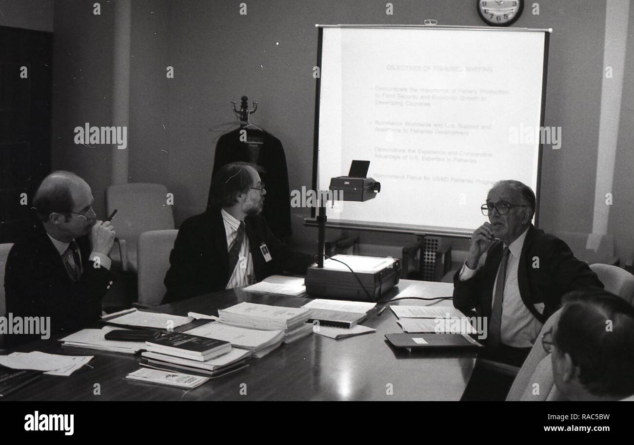 THESE GROUP OF MEN ARE HAVING A CONVERSATION AT A BUINESS MEETING Stock ...