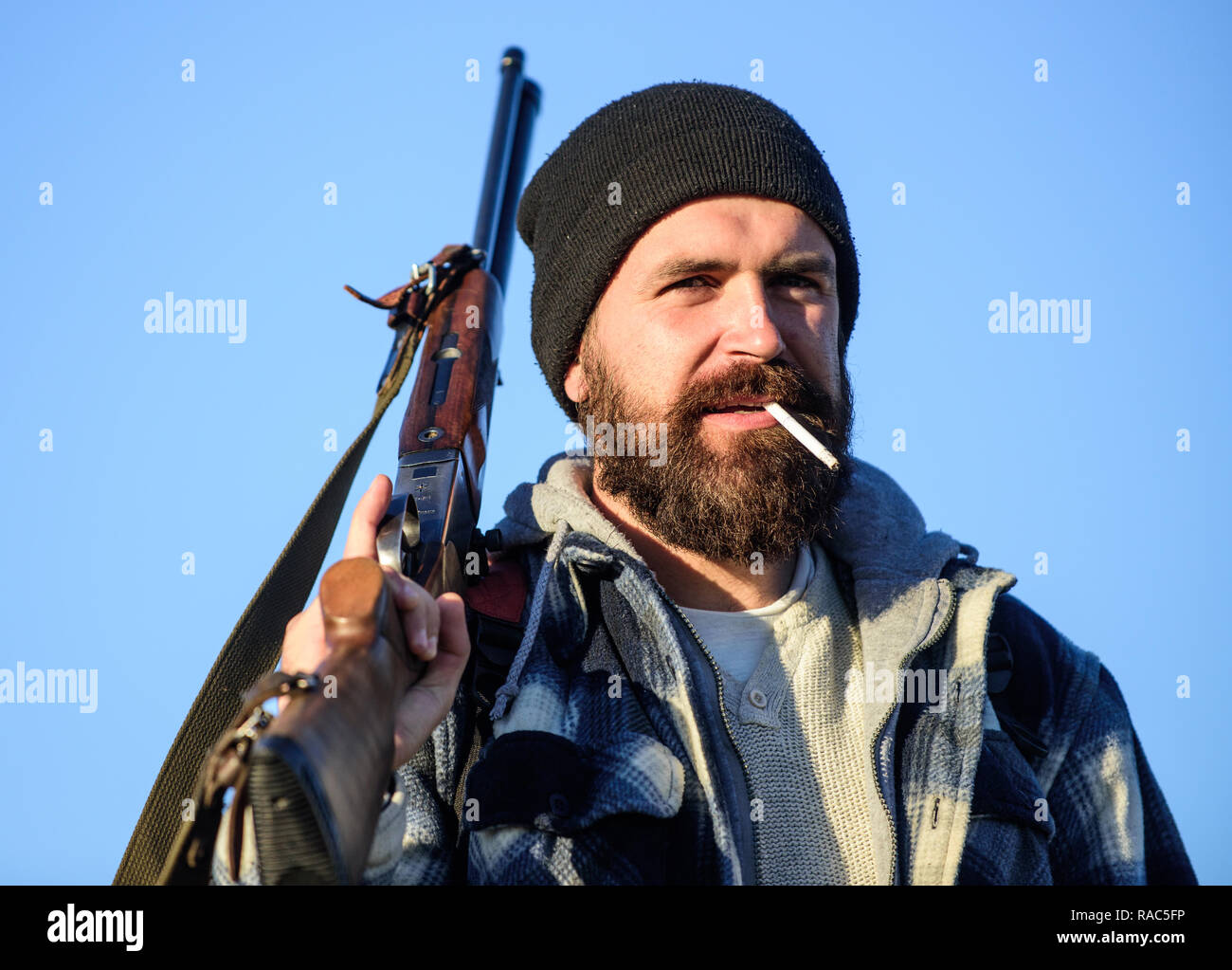 Guy bearded hunter spend leisure hunting and smoking. Hunting masculine ...