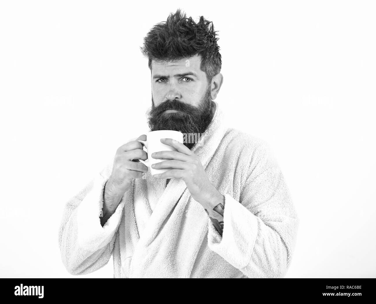 Macho drowsy, sleepy with strict face drinks coffee in morning. Morning ...