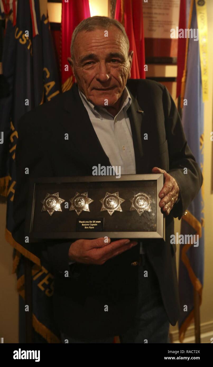 Lt. Col. Kenneth Pipes, a U.S. Marine veteran, receives a memento to ...