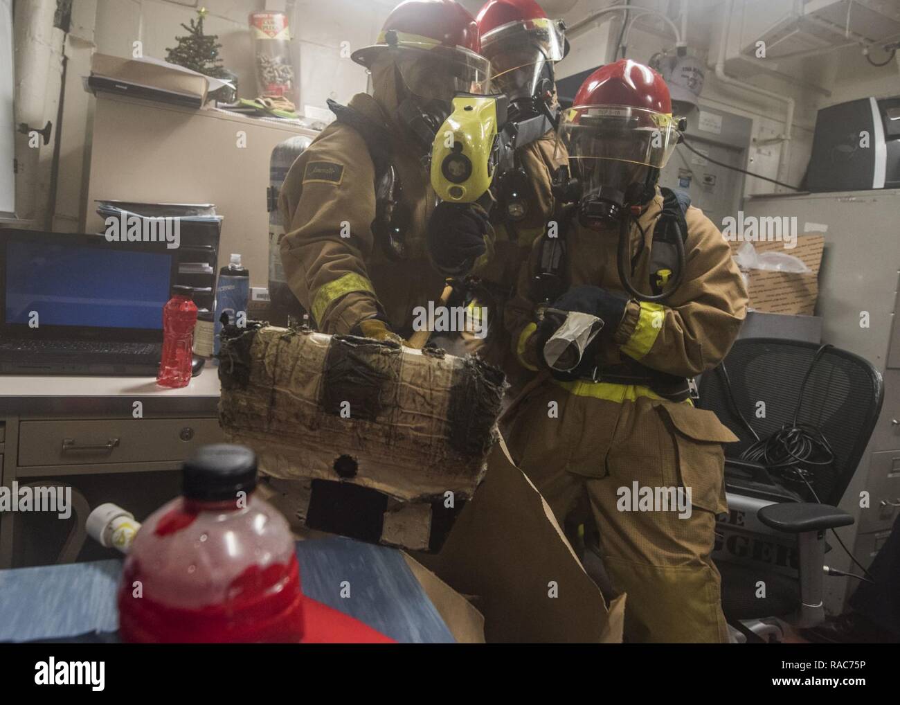 ARABIAN SEA (Jan. 13, 2017) Fireman Jake Lindsay uses a rake to ...