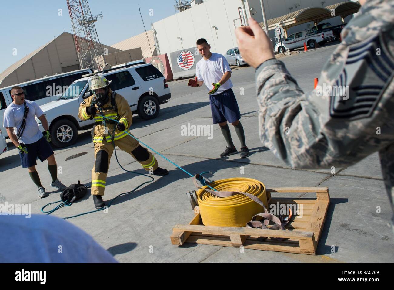 A 380th Expeditionary Civil Engineer Squadron firefighter pulls an ...