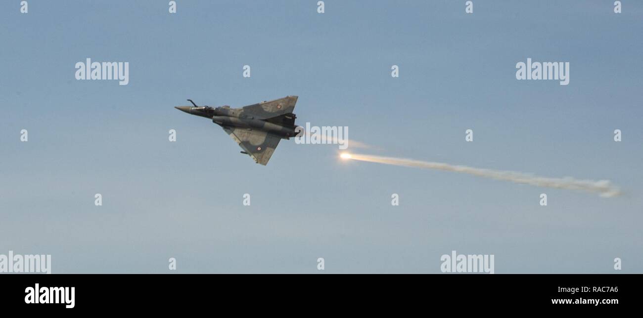 A French Mirage fighter aircraft drops flares as it performs a high ...