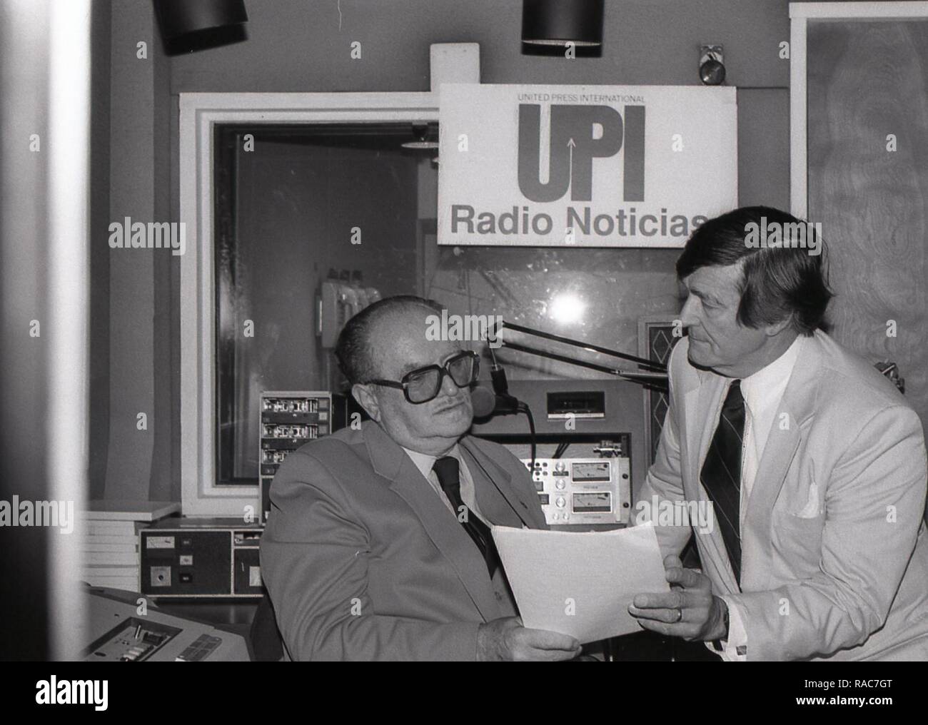 MAN GOING OVER HIS NOTES AT THE RADIO STATION UPI Stock Photo - Alamy