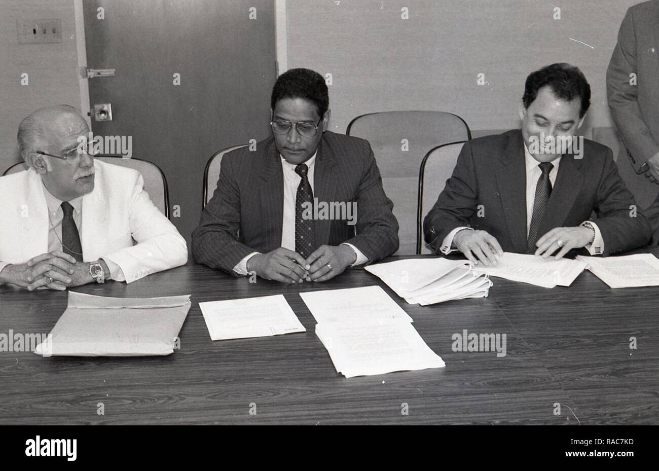 THREE MEN SITTING AT THE TABLE HAVING A MEETING Stock Photo - Alamy