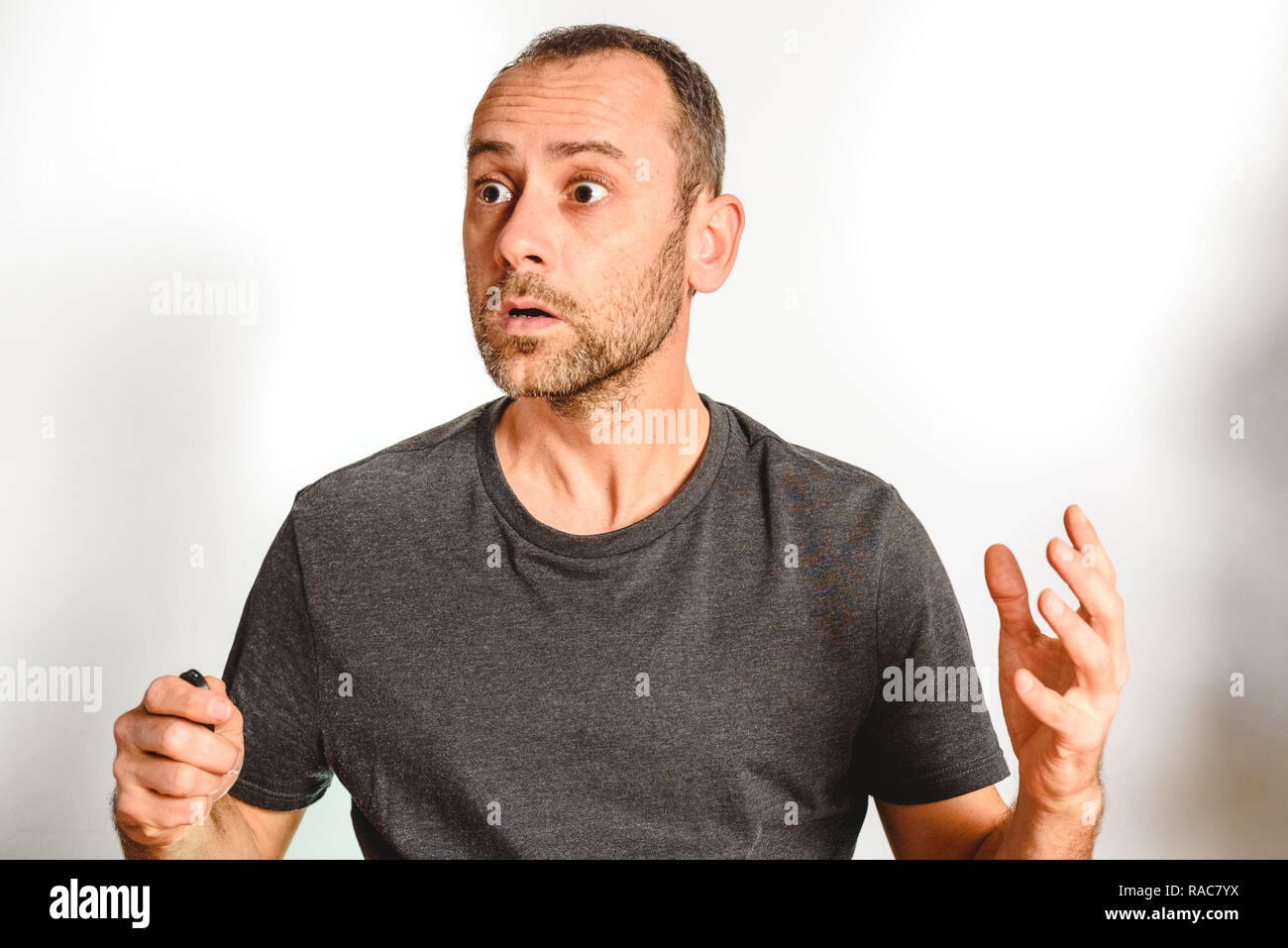 Man in studio overwhelmed, stressed and surprised, model expressions ...