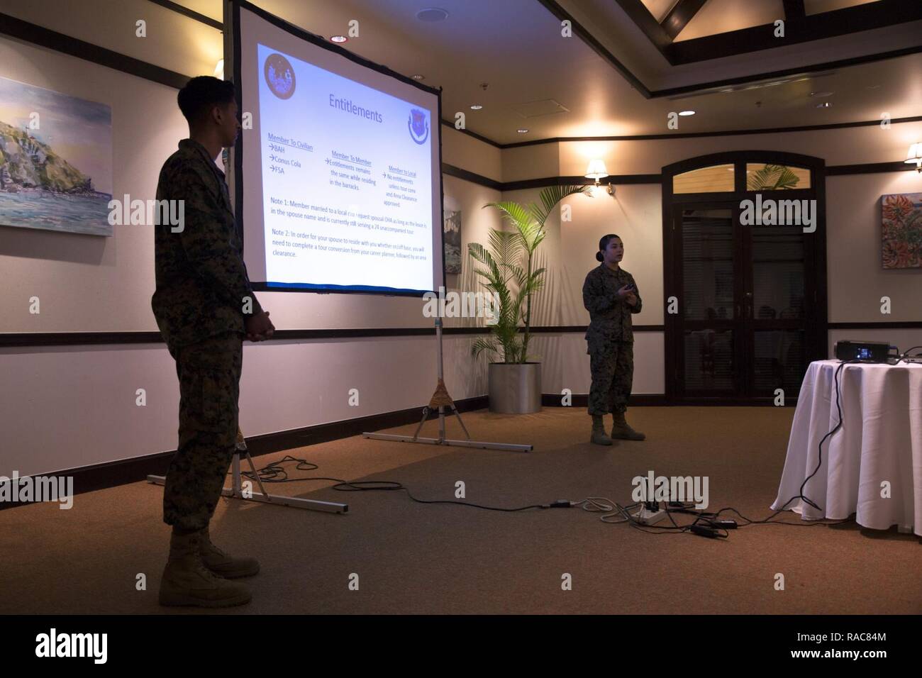 Lance Cpl. Angel Cisneros, left, and Lance Cpl. Erica Cox explain the ...