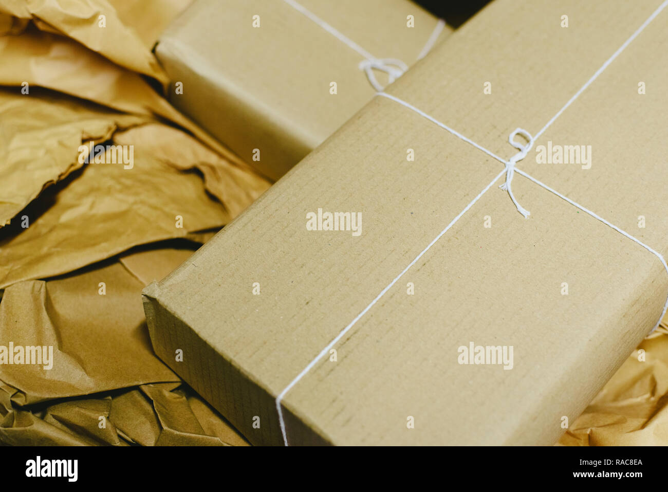 Gifts in simple cardboard boxes with white cord Stock Photo - Alamy