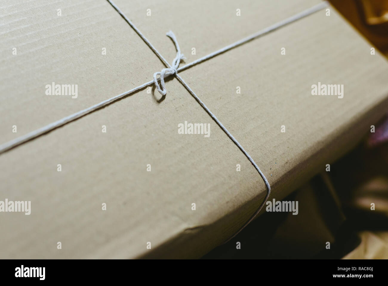 Gifts in simple cardboard boxes with white cord Stock Photo - Alamy