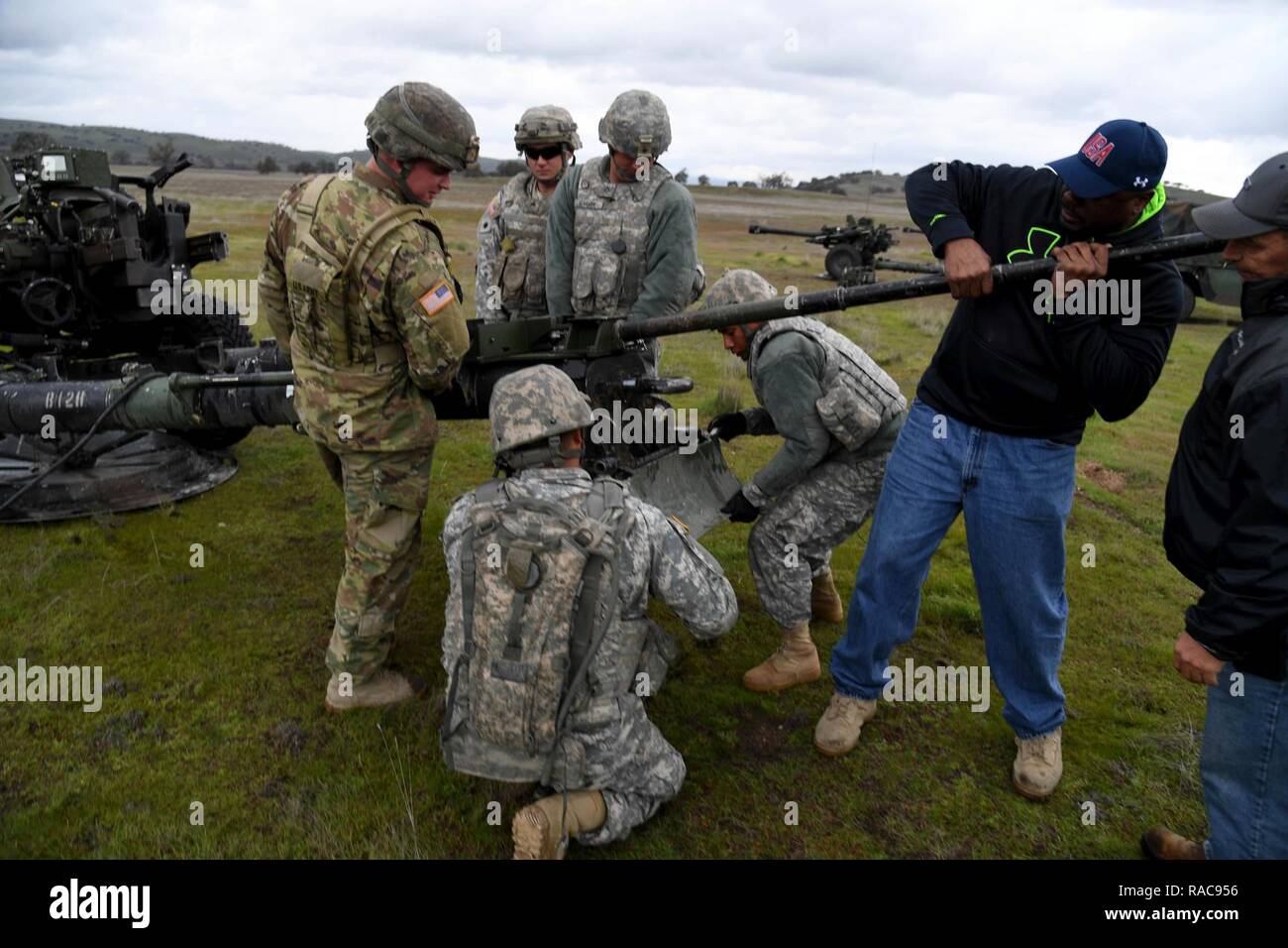 Alpha and Bravo Battery, 1-143rd Field Artillery, prepare an M119A3 ...