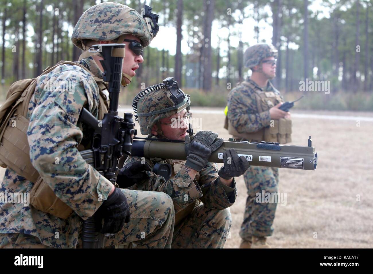 Lance Cpl. Michael G. Battaglia (center) looks down range with Cpl ...