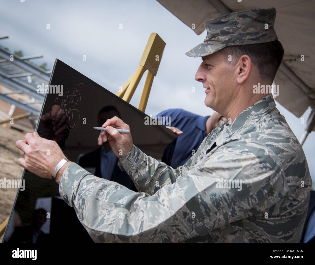 Col. Craig Johnson, 96th Civil Engineer Group commander, adds a ...