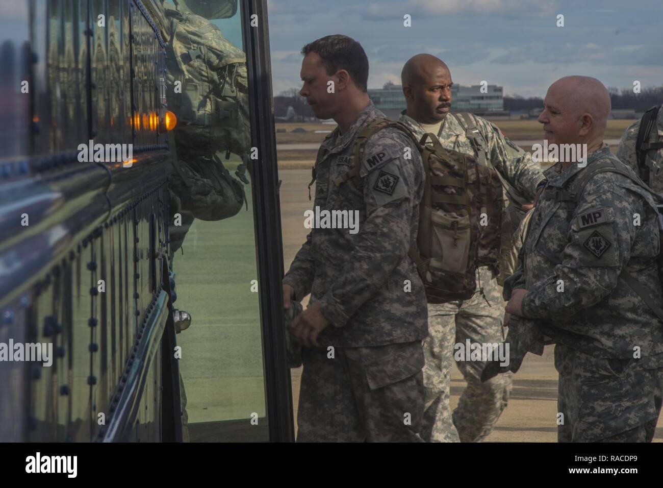Mississippi Army National Guard members board a bus at Joint Base ...