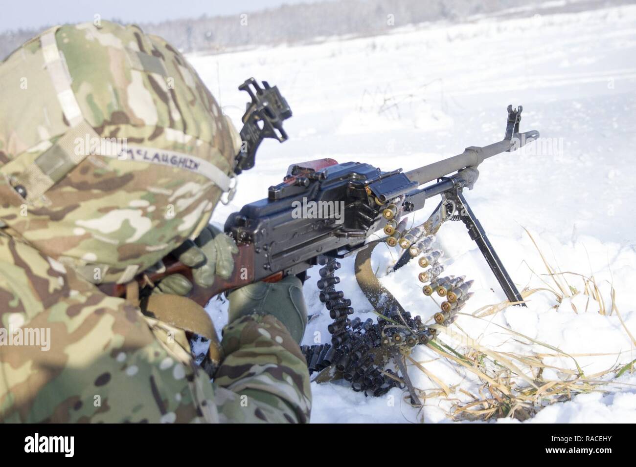 Sgt. David McLaughlin of Yukon, Oklahoma fires a PKM machine gun during ...