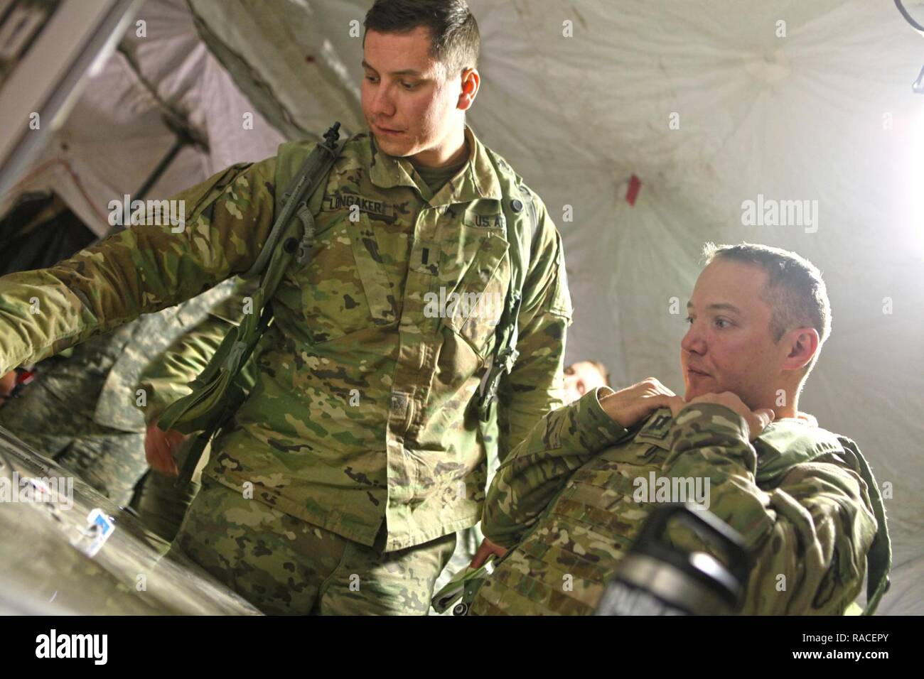 U.S. Army 1st Lt. Nick Longaker briefs Capt. Dan Magar from 1/25th ...