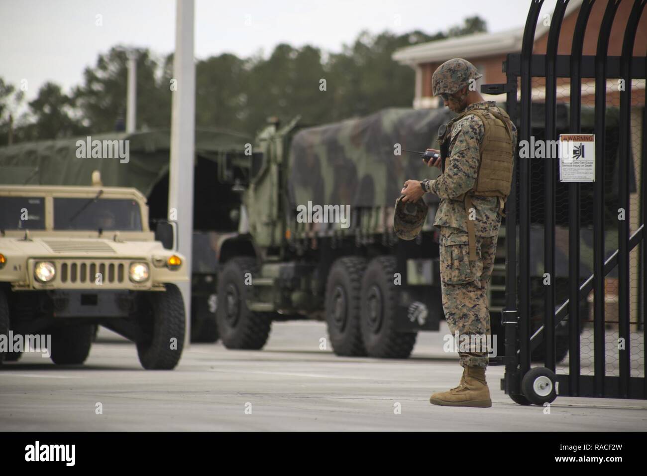 A Marine communicates with vehicles in a convoy during a Strategic ...