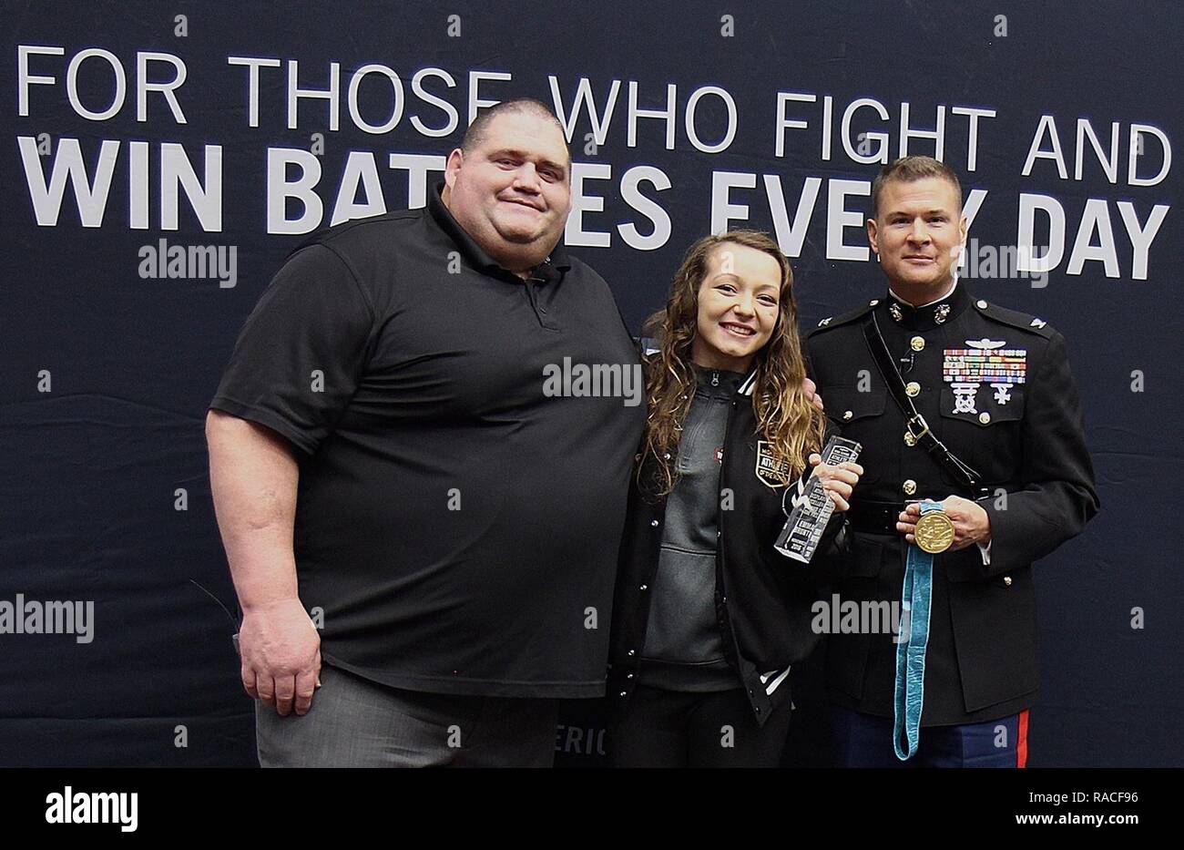 Emma Bruntil stands with American Olympian Rulon Gardner and Col. Terry ...