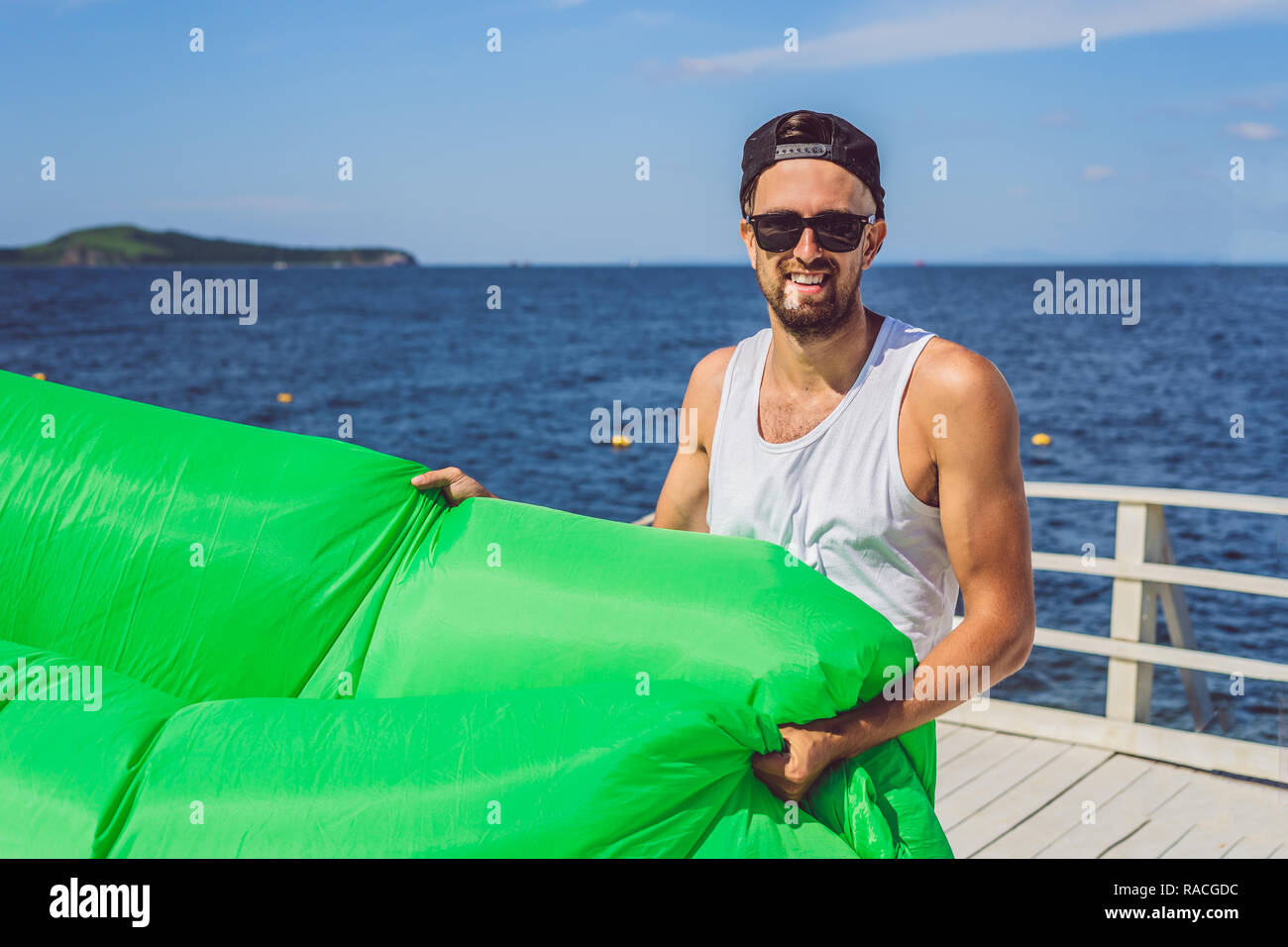 Man tries to inflate an air sofa. lamzac Stock Photo - Alamy