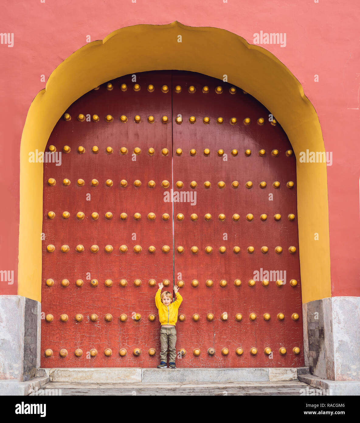 Boy tourist on the background of the large Chinese gates. Travel with ...