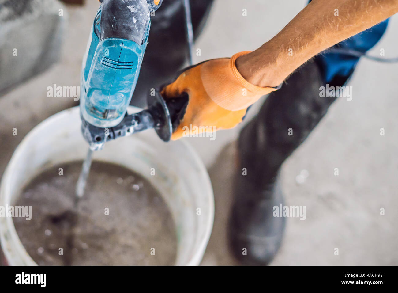 Man making cement with a construction mixer in a bucket Stock Photo - Alamy