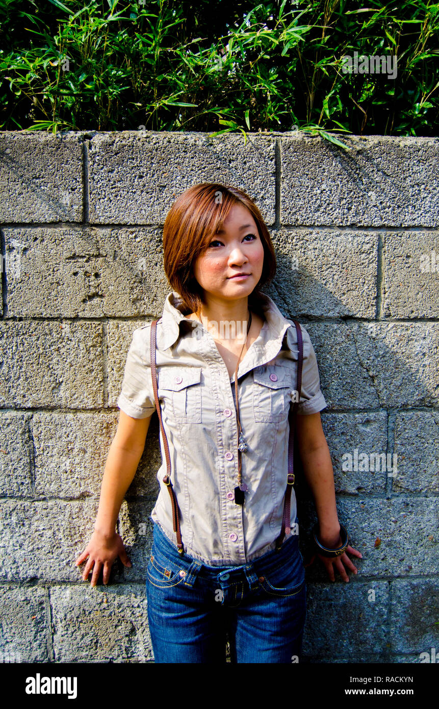 Asian female model poses for pictures on the street Stock Photo - Alamy