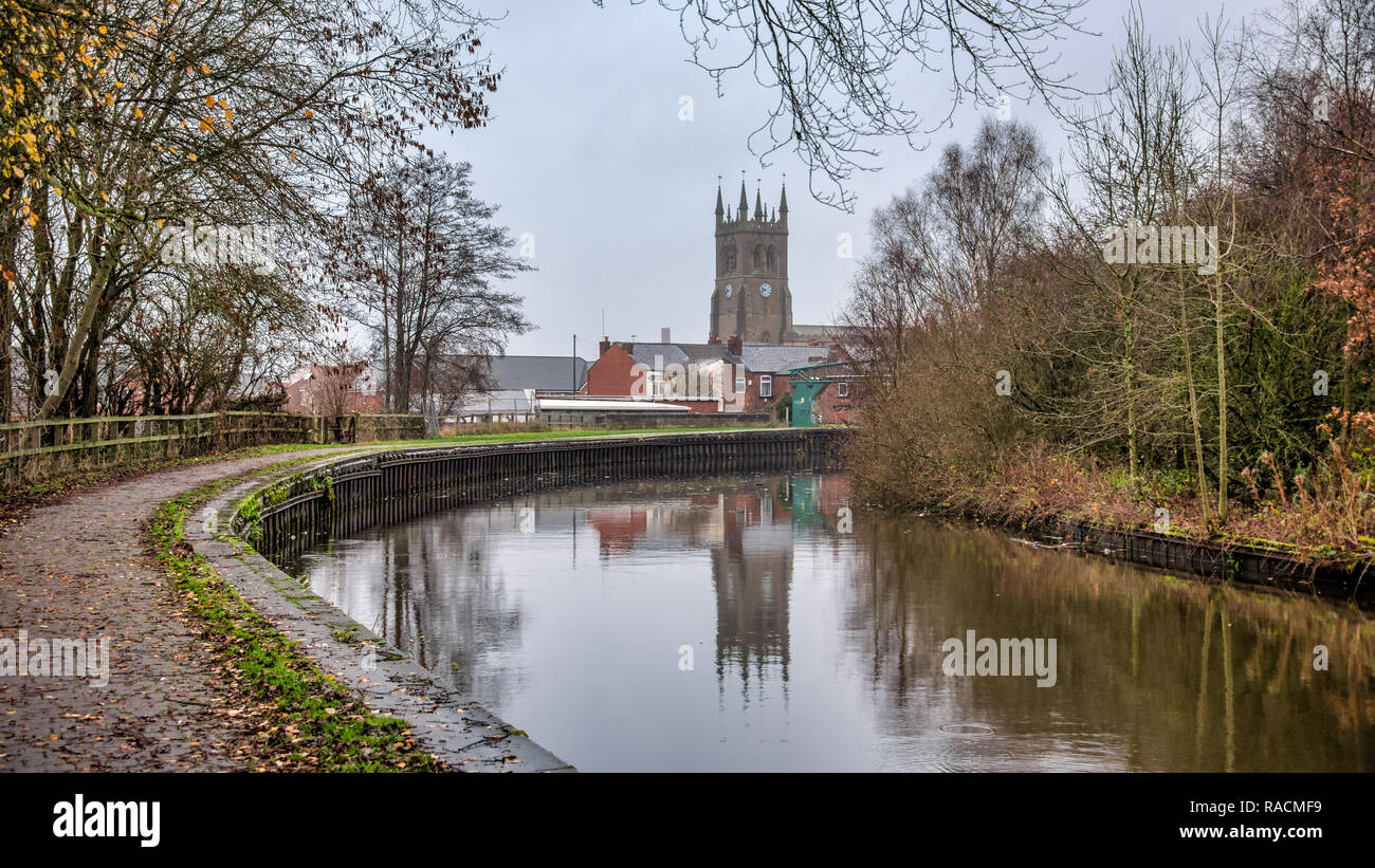 A landscape looking down a canal at a church spire in the distance. The ...