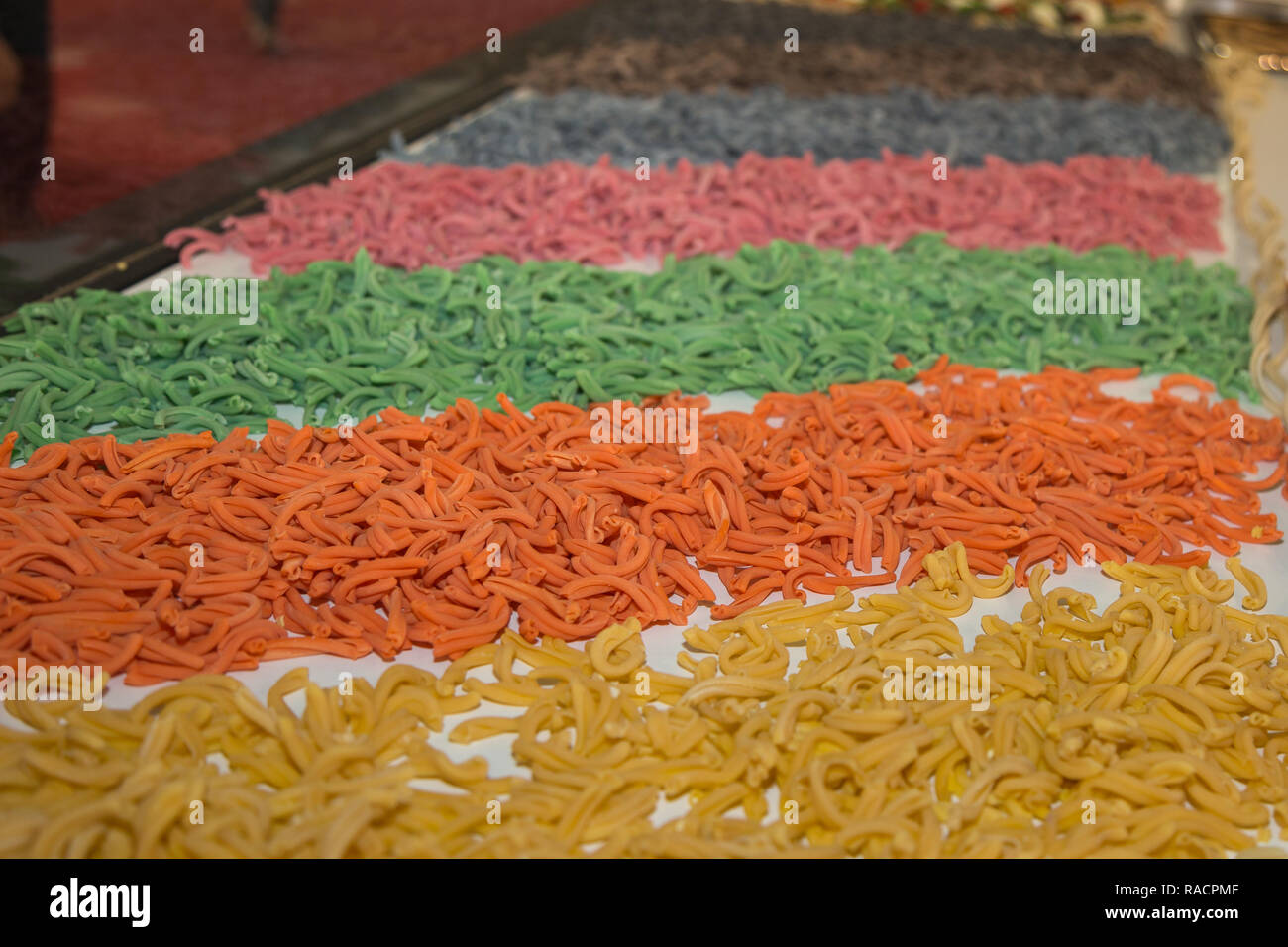 Display of a Food Store with Various Rows of Raw Coloured Pasta Stock ...