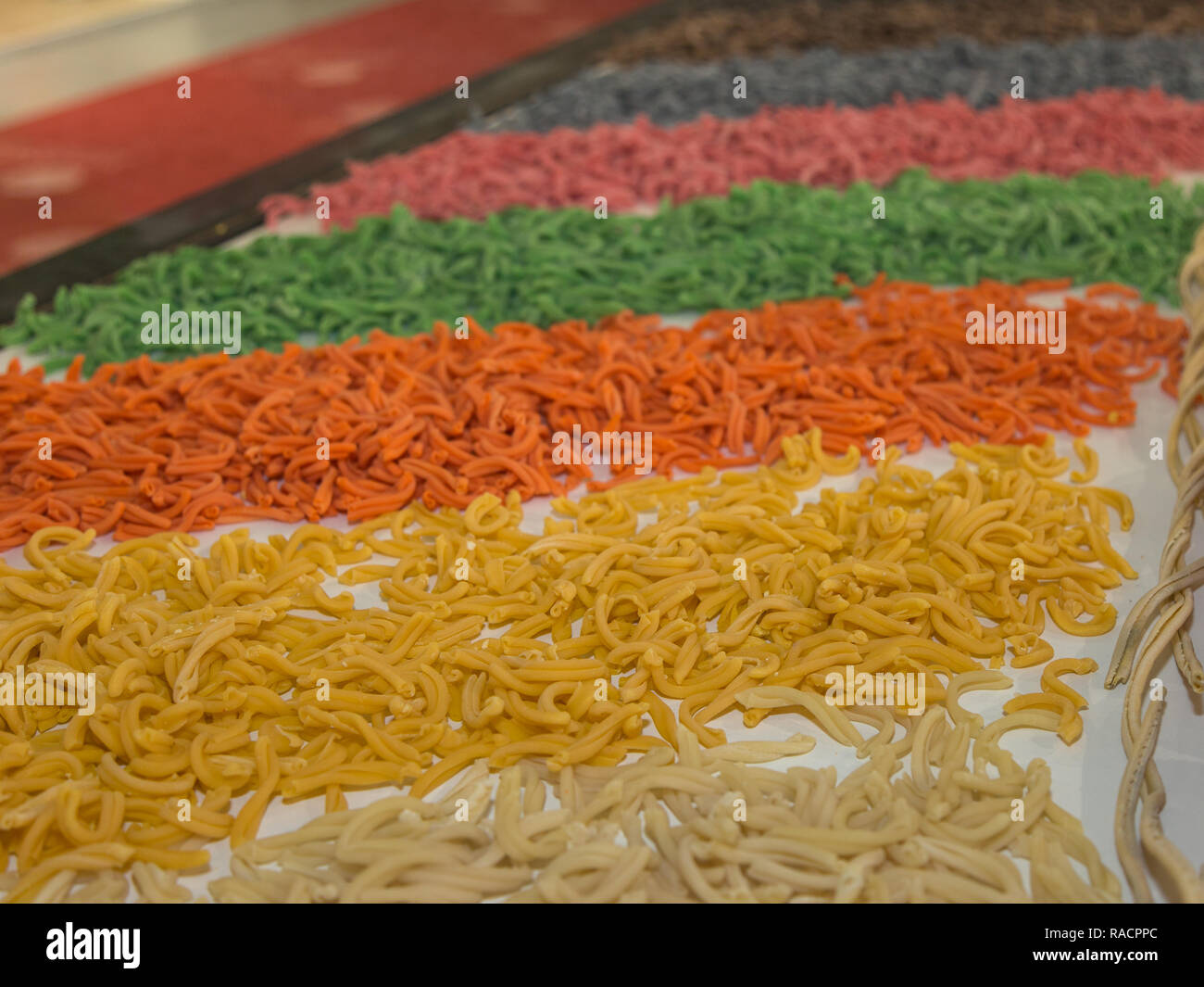 Display of a Food Store with Various Rows of Raw Coloured Pasta Stock ...