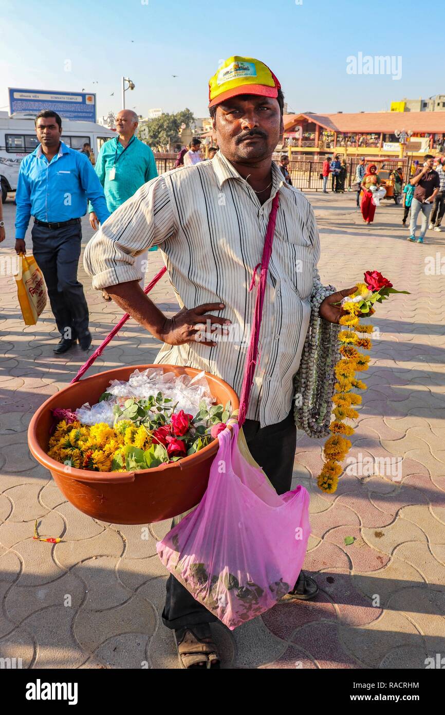A flower seller smiling and posing for photograph/Somnath Temple ...