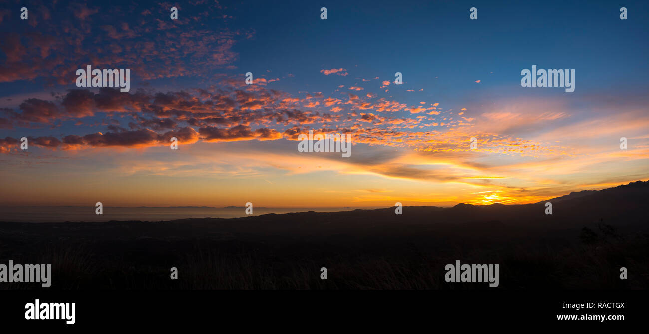 Panoramic view of a bright red orange sunset, with stratocumulus, Mijas ...