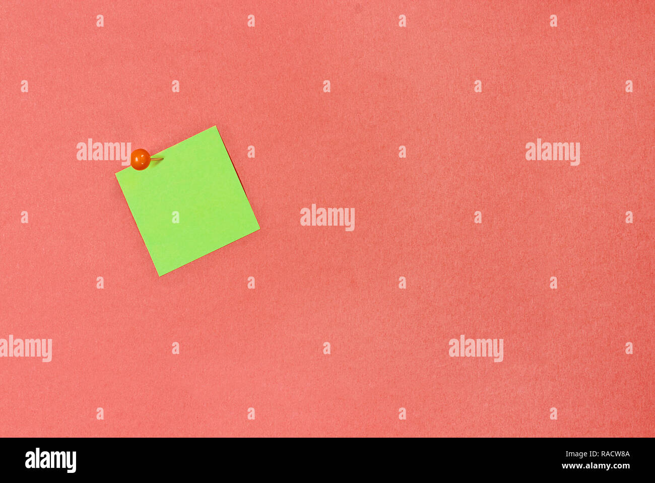 Blank green note pad paper over coral color background with free space ...