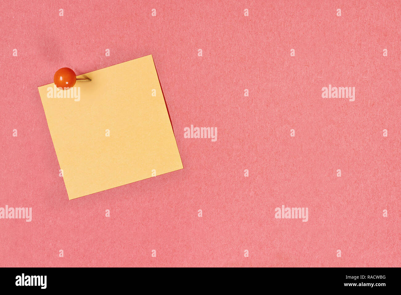 Blank yellow note pad paper over coral color background with free space ...