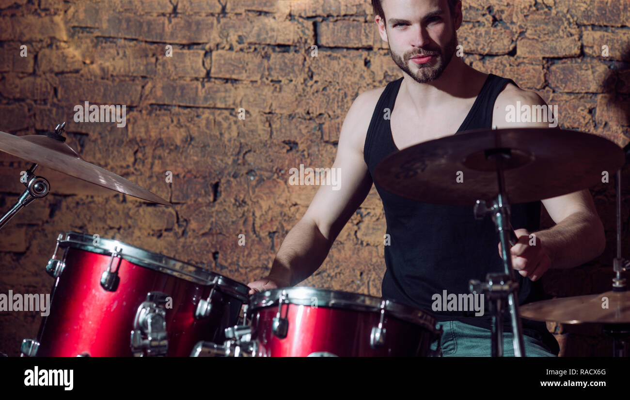 Heartbeat of the band. Man drummer playing musical instrument. Handsome ...