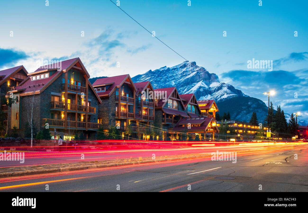 Trail lights on Banff Avenue and mountains in background at dusk, Banff ...