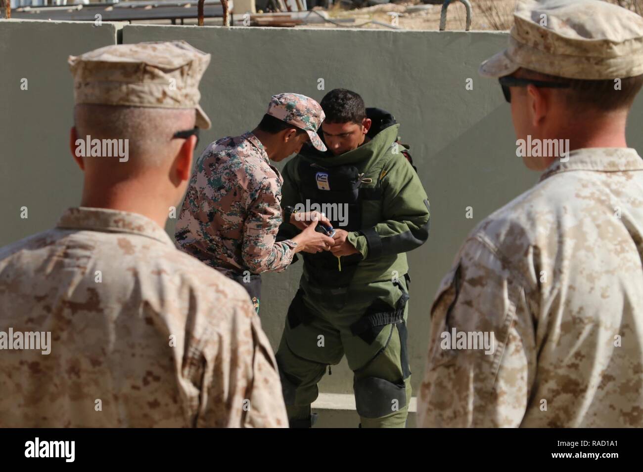 U.S. Marines observe as an explosive ordinance technician from the ...