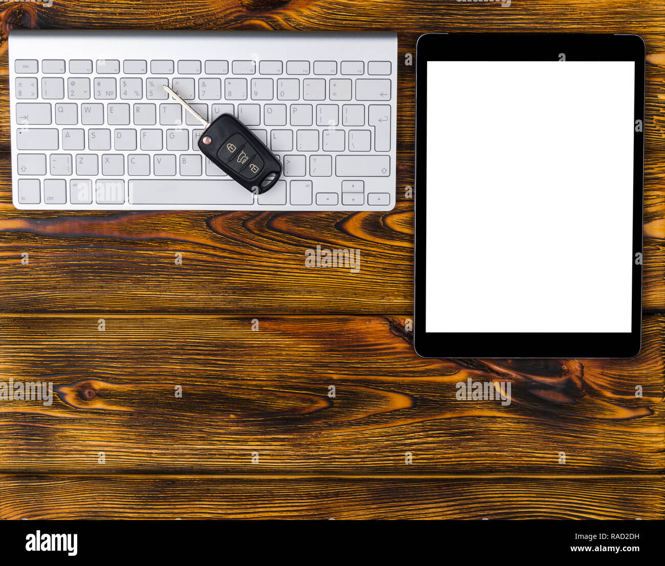 Business Workplace with wireless keyboard, tablet computer and car keys ...