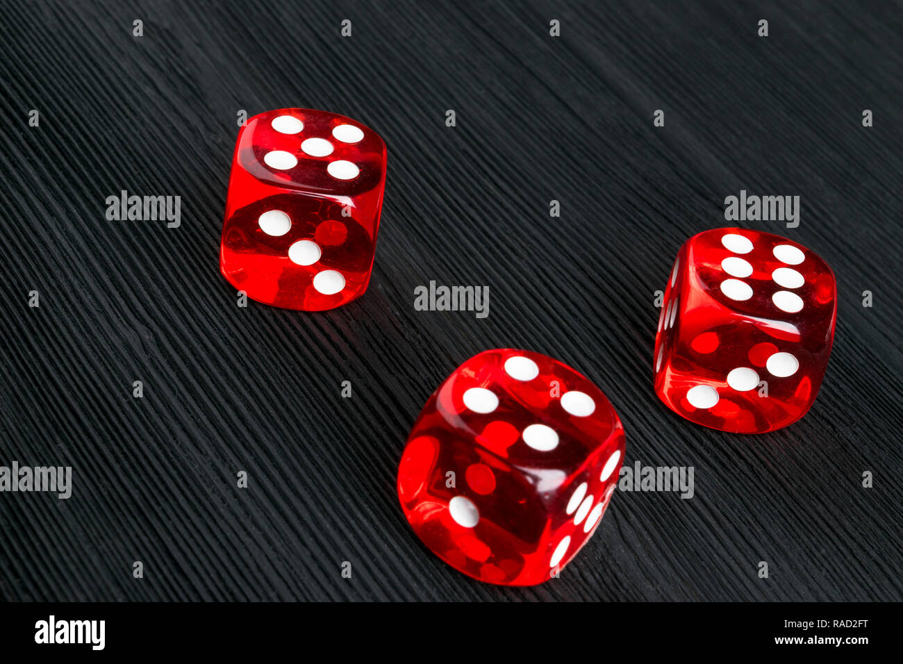 risk concept - playing dice at black wooden background. Playing a game ...