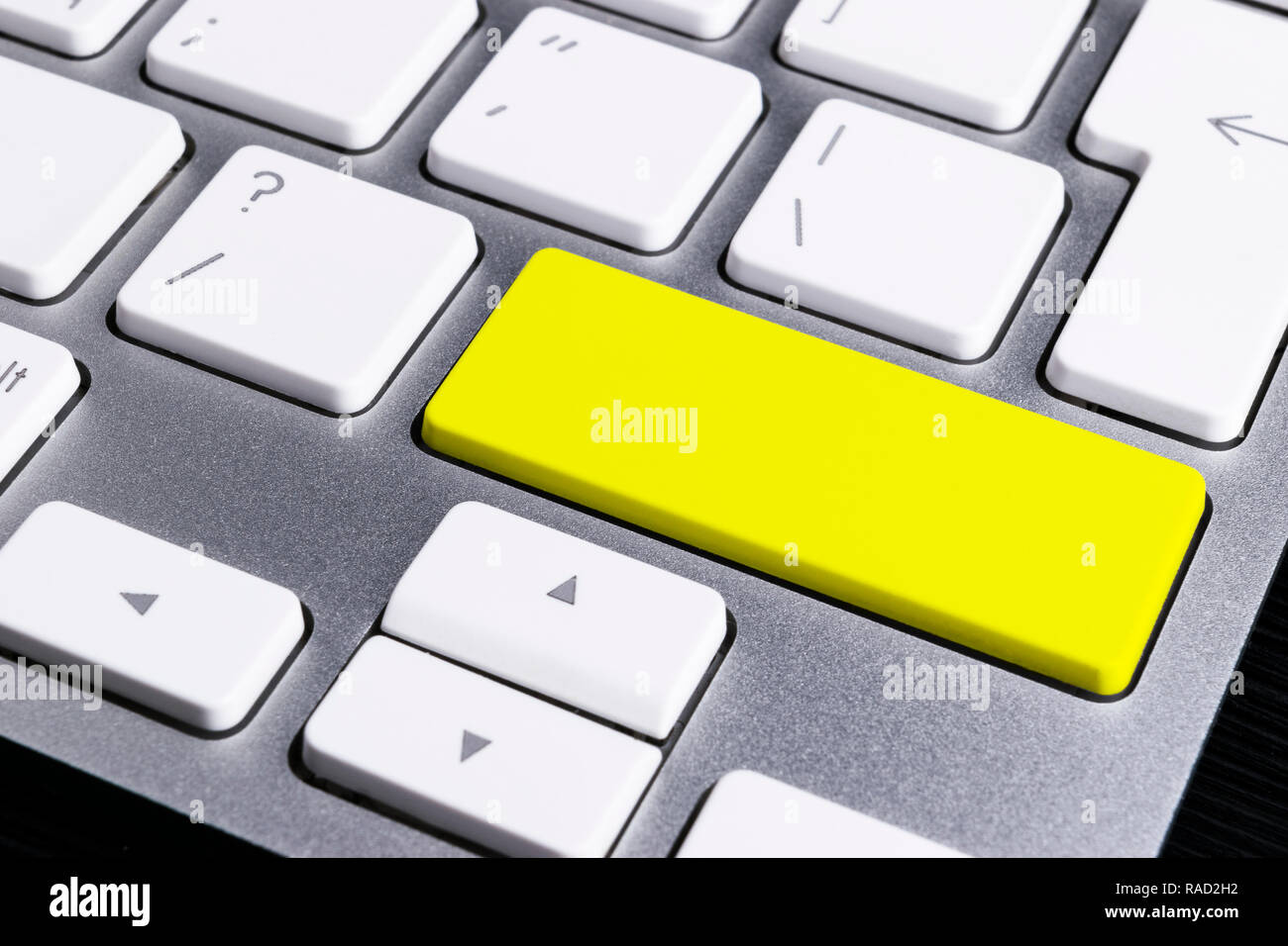 Close up view of a Computer notebook keyboard with one yellow key ...