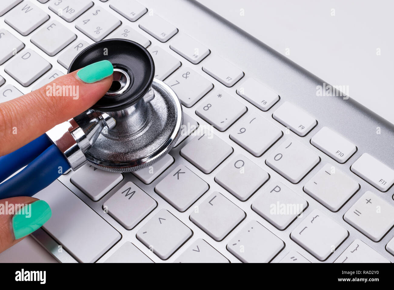 technician female (woman) hand using stethoscope for examines computer ...