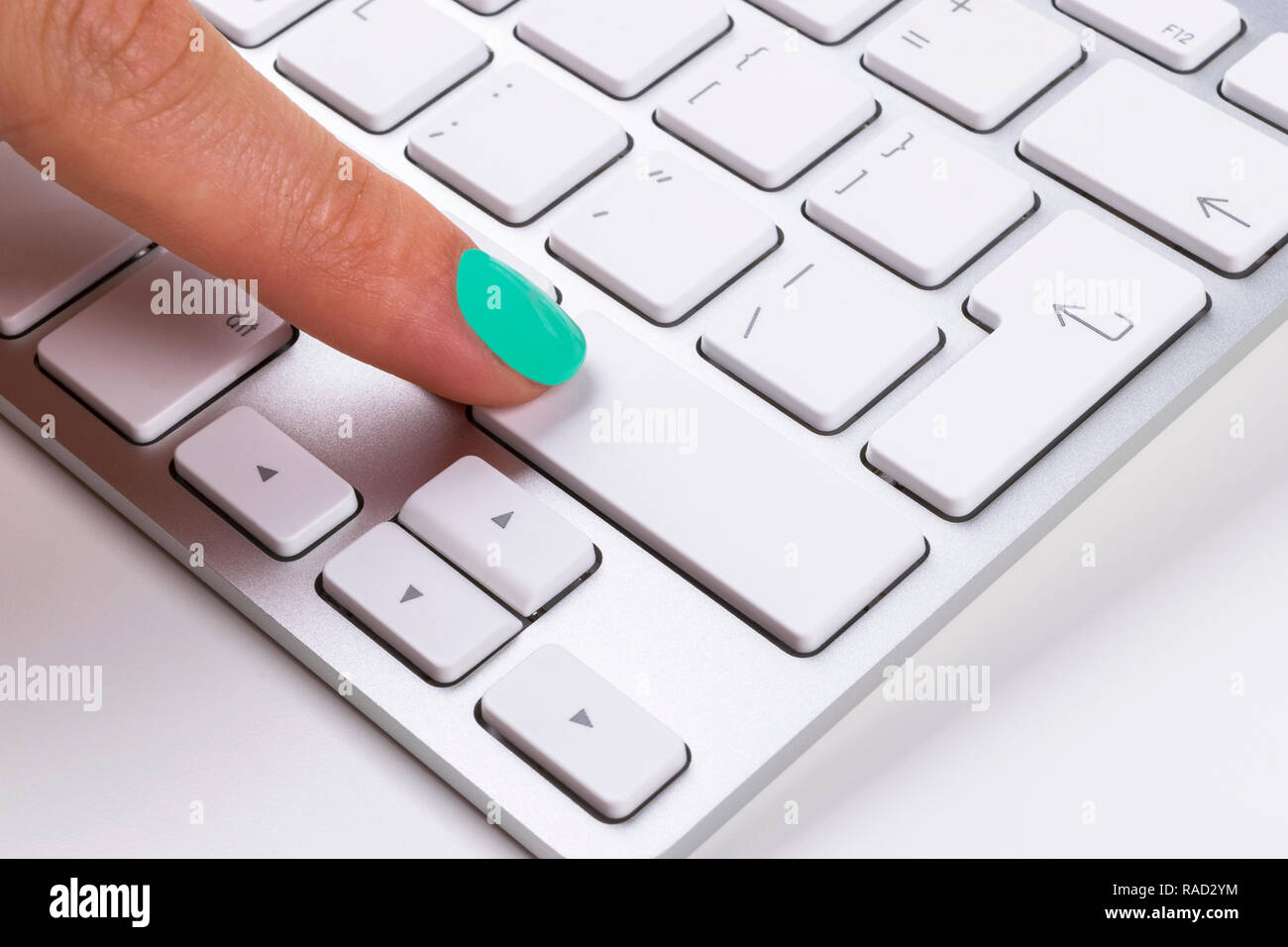Close up view of a Finger Pushing Button on Aluminum Keyboard. Finger ...