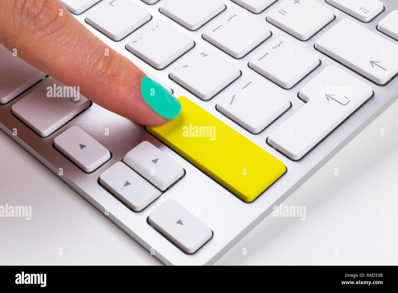 Close up view of a Finger Pushing on a yellow Button of computer ...