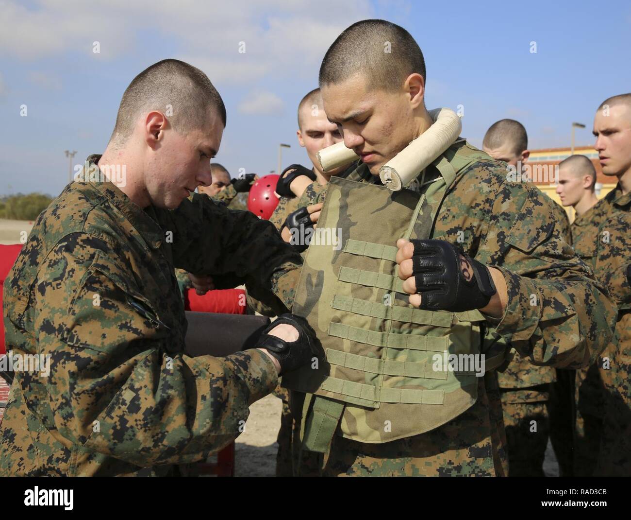 A recruit from Mike Company, 3rd Recruit Training Battalion, prepares a recruit for his fight ...