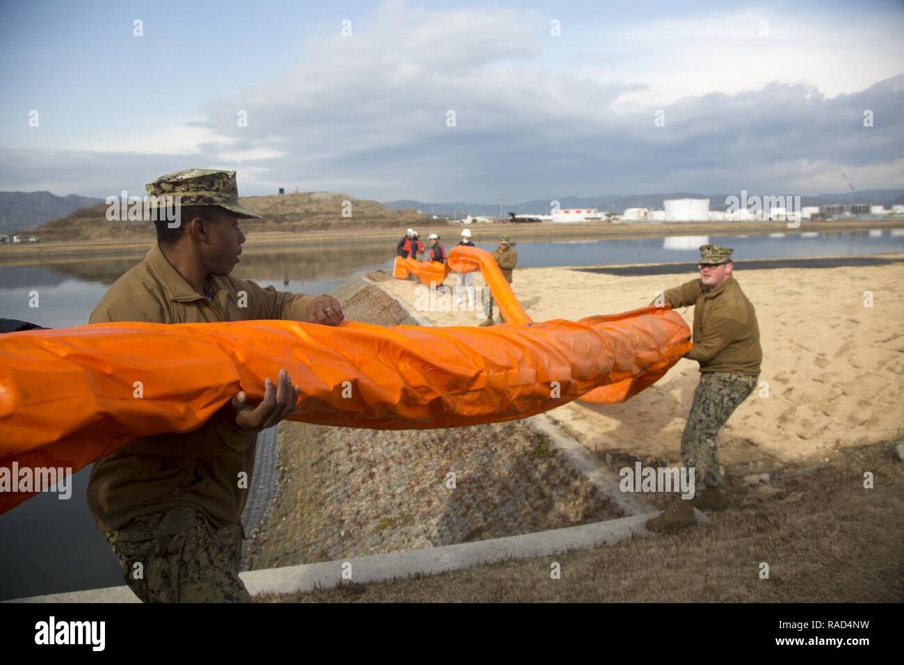 U.S. Sailors and facilities personnel respond to a simulated spill ...