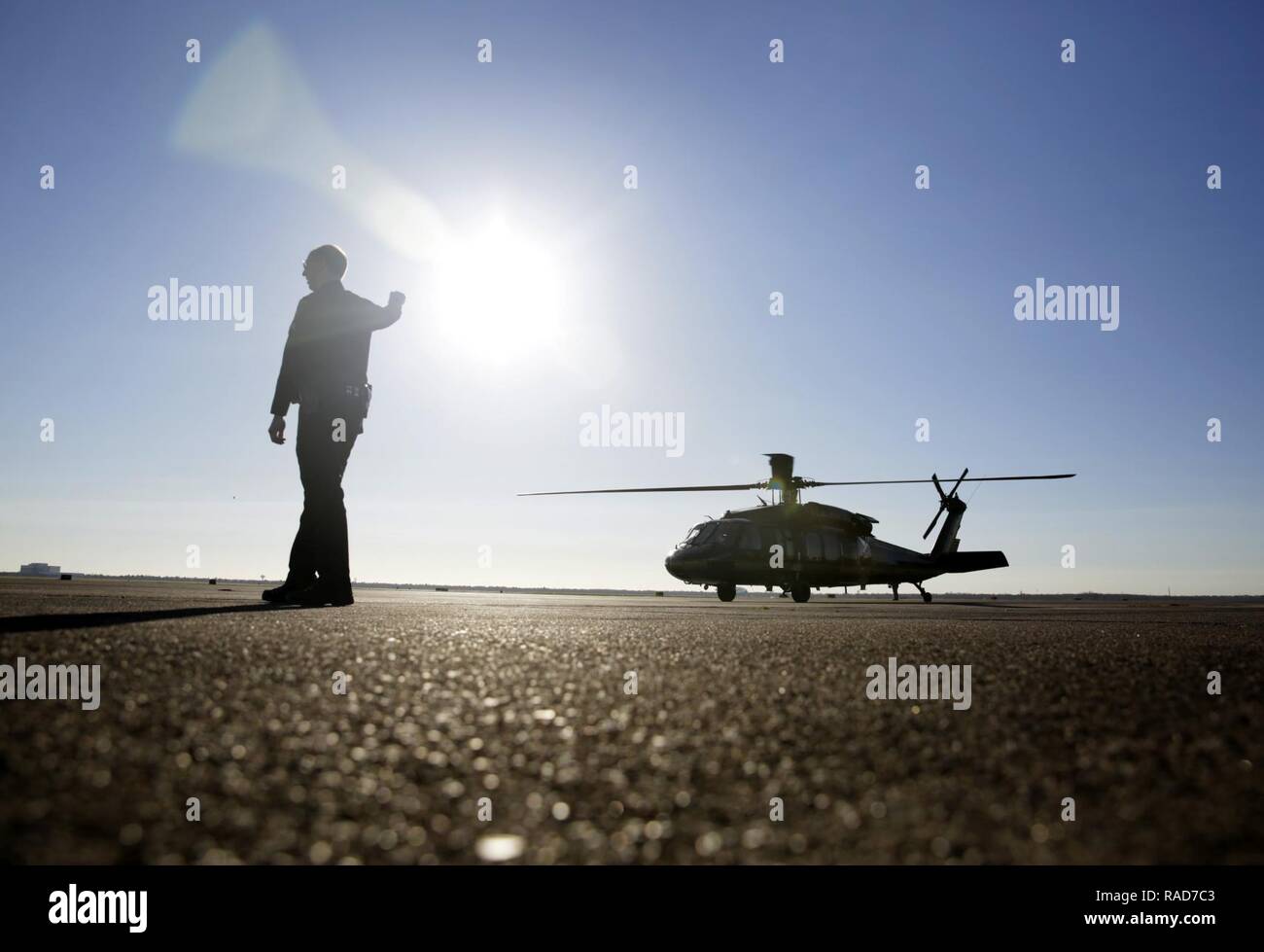 A ground support officer signals for a U.S. Customs and Border ...