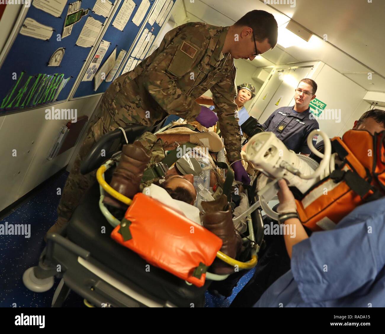 A Royal Marine with simulated injuries is brought into the HMS Ocean ...