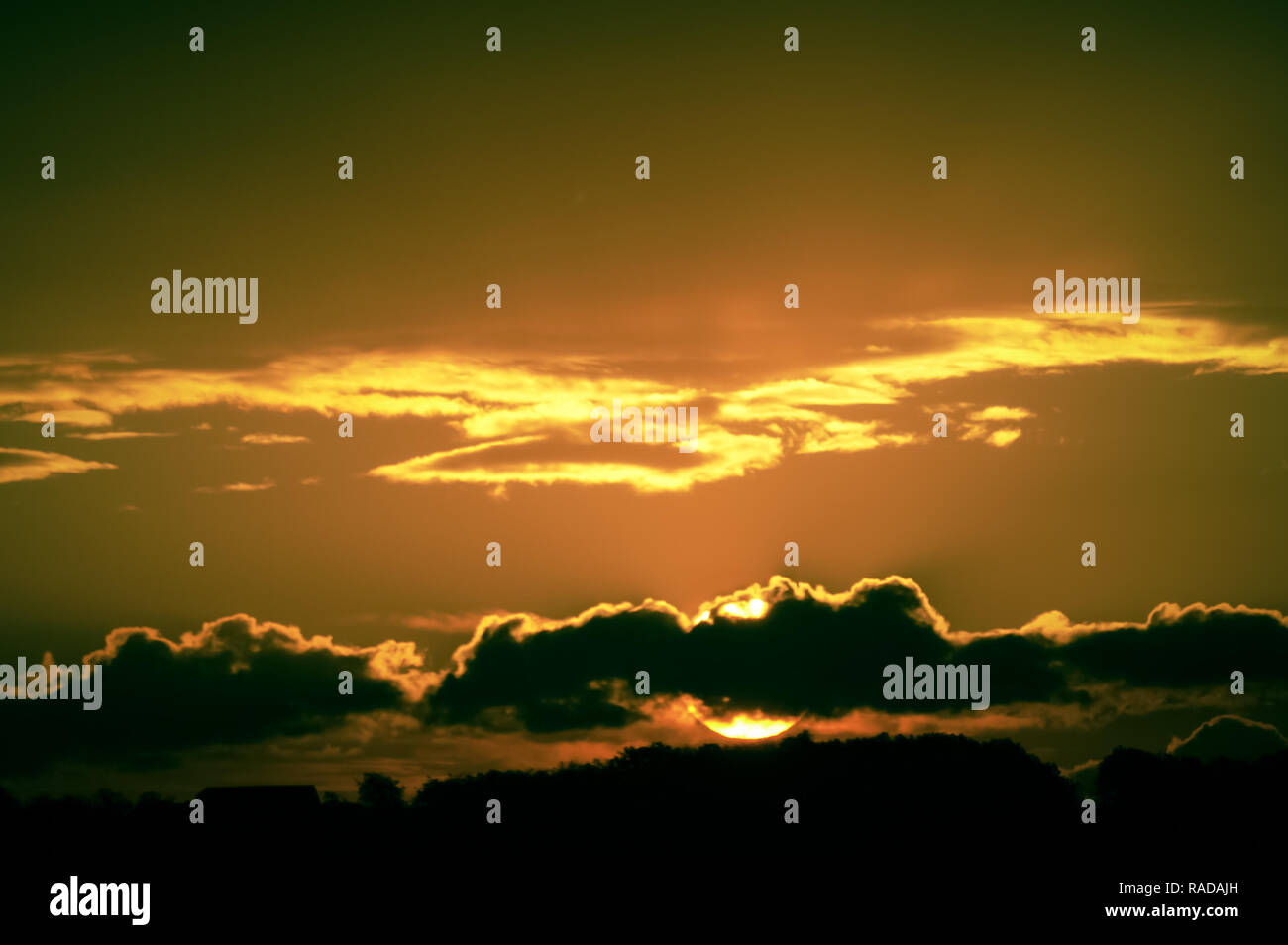 Bright big sun on the sky with clouds Stock Photo - Alamy