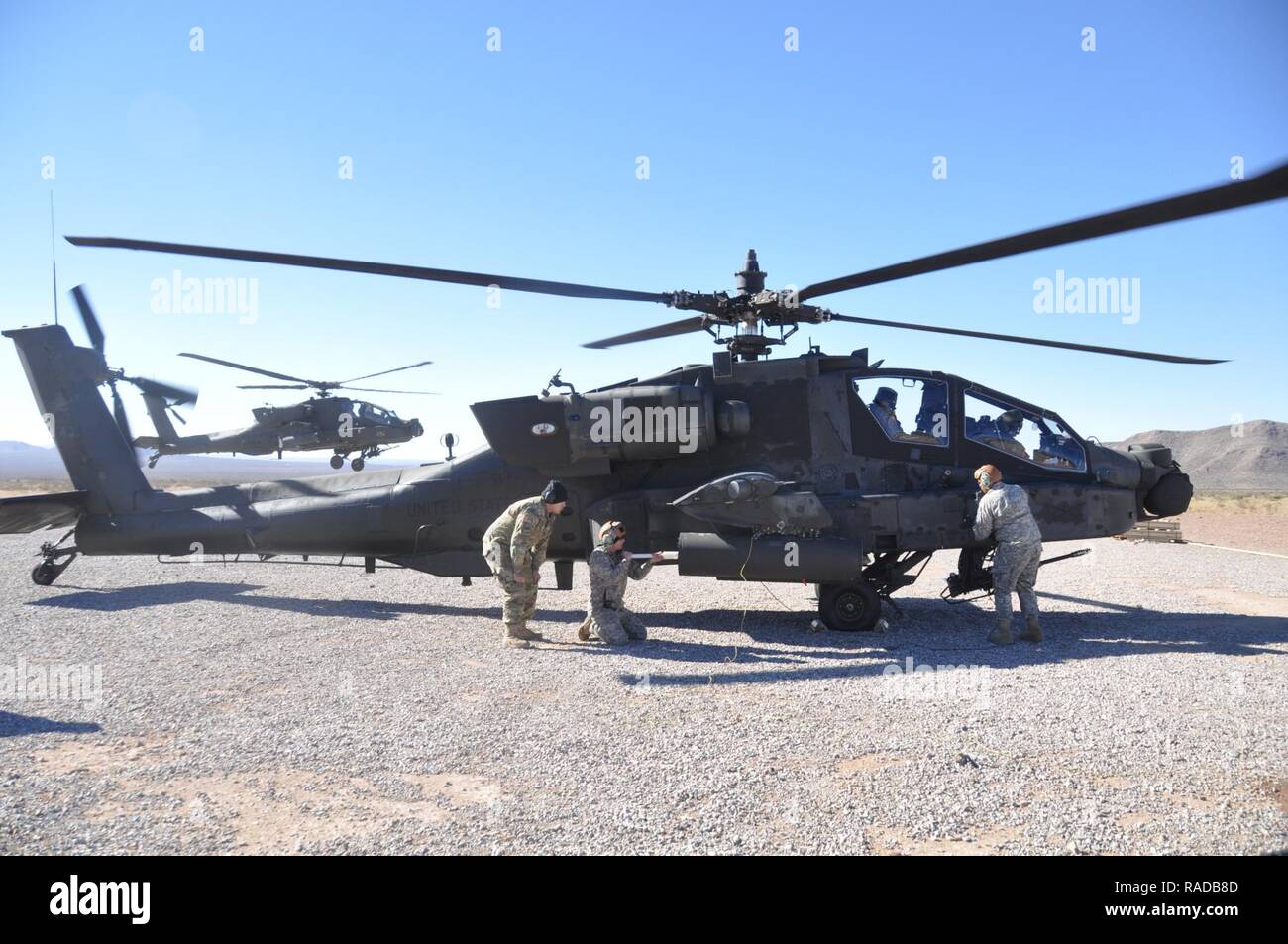 An Apache AH-64D comes in for a landing at a forward arming and ...